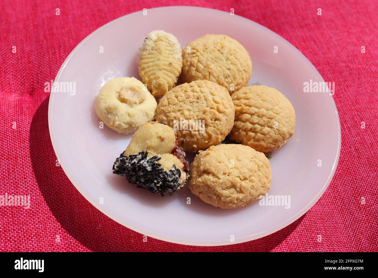 Eid biscuits in the white plate and pink background for Christmas and ...