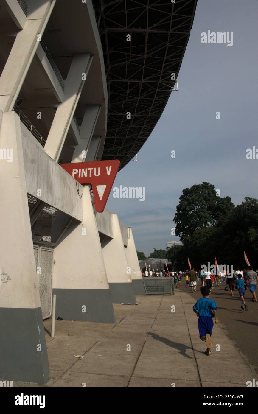 An elementary student wearing his school's sport outfit running outside ...