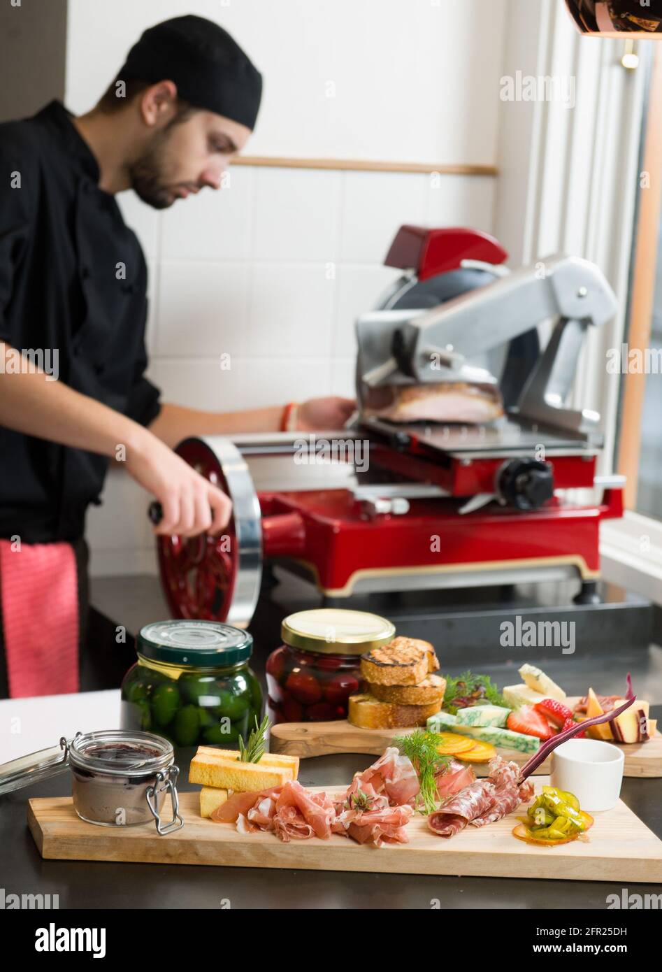 A chef prepares a Charcuterie, or cold cut, platter, at a Whistler ...