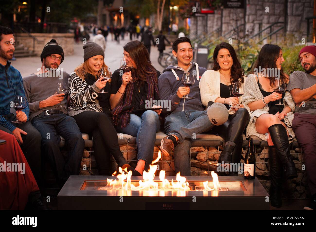 A group of friends at a fireplace booth at a Whistler restaurant Stock ...