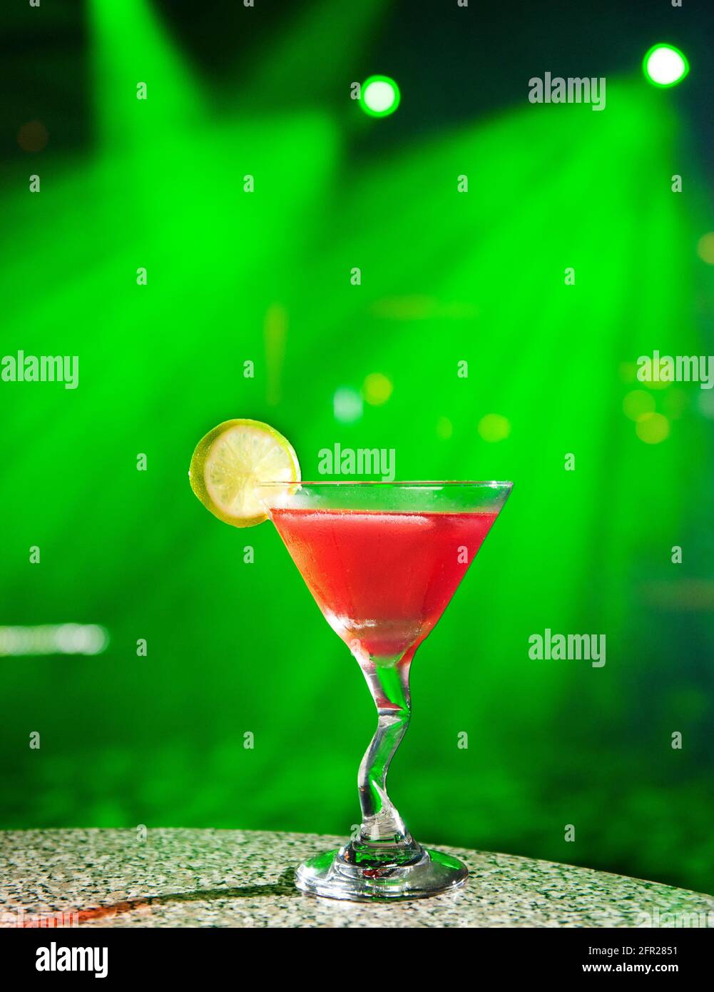 A red Martini cocktail on a green background Stock Photo - Alamy