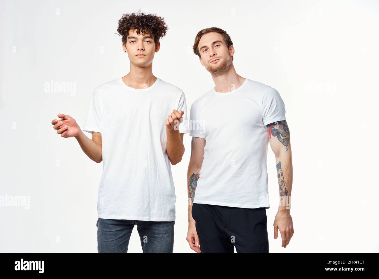 two funny friends in white t-shirts laughing positive emotions Stock ...