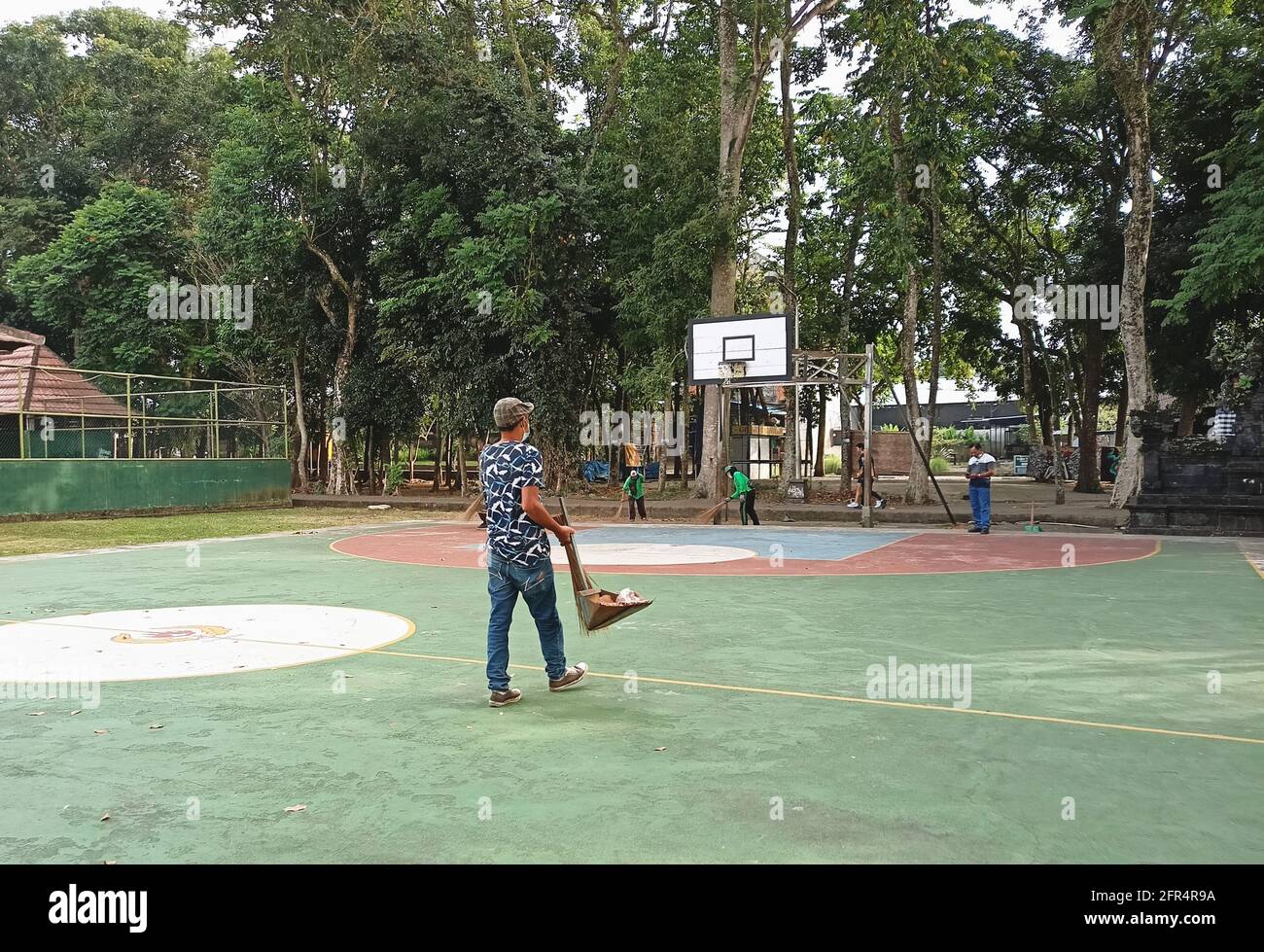 a photo of a janitor cleaning the basketball court Stock Photo - Alamy