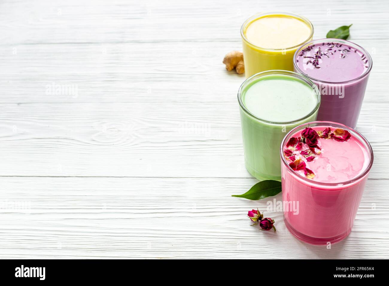 Green, yellow and pink latte. Hot colorful coffee or tea with milk ...