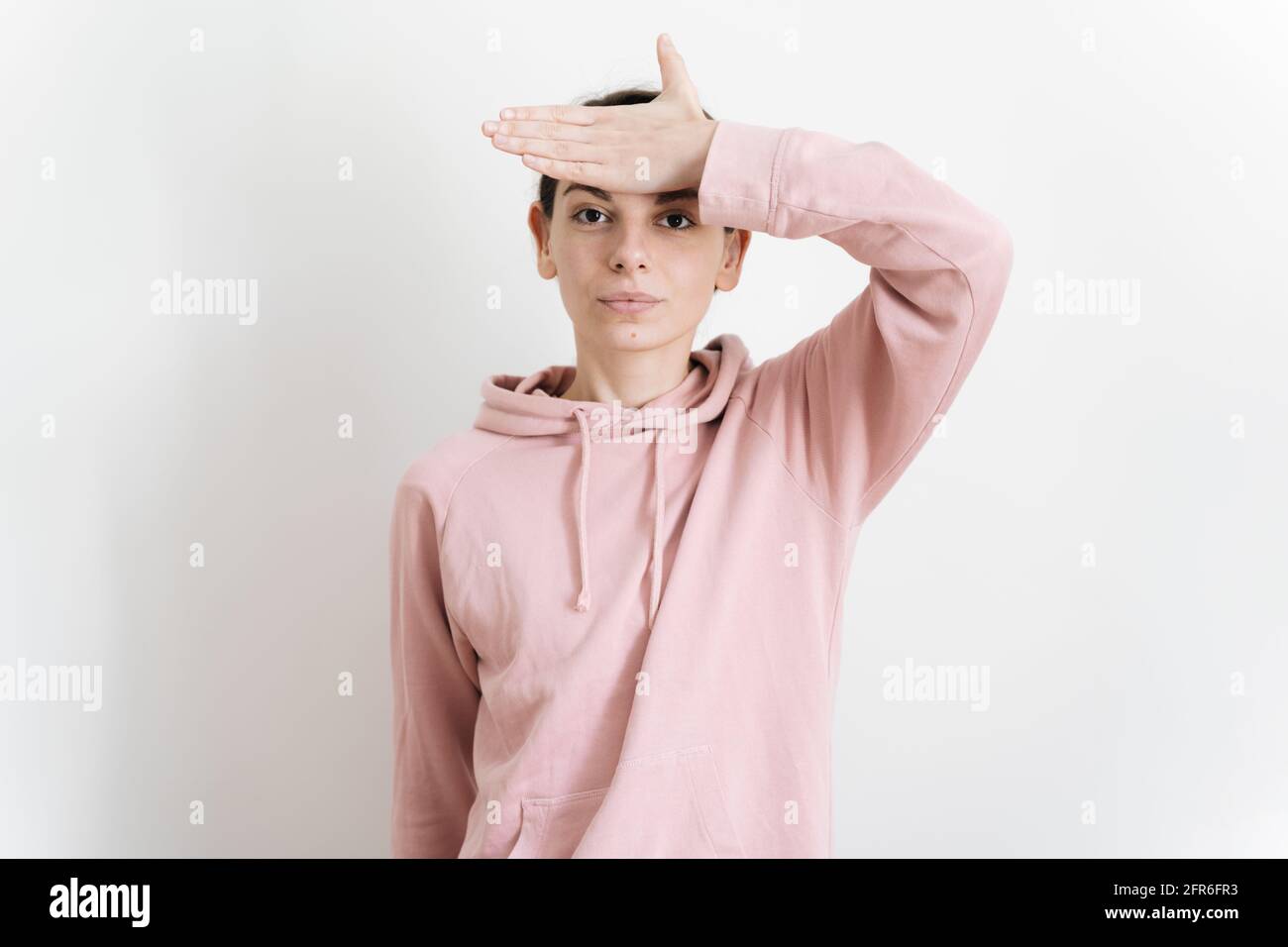 Beautiful young millennial woman doing face yoga at home. Fascial ...