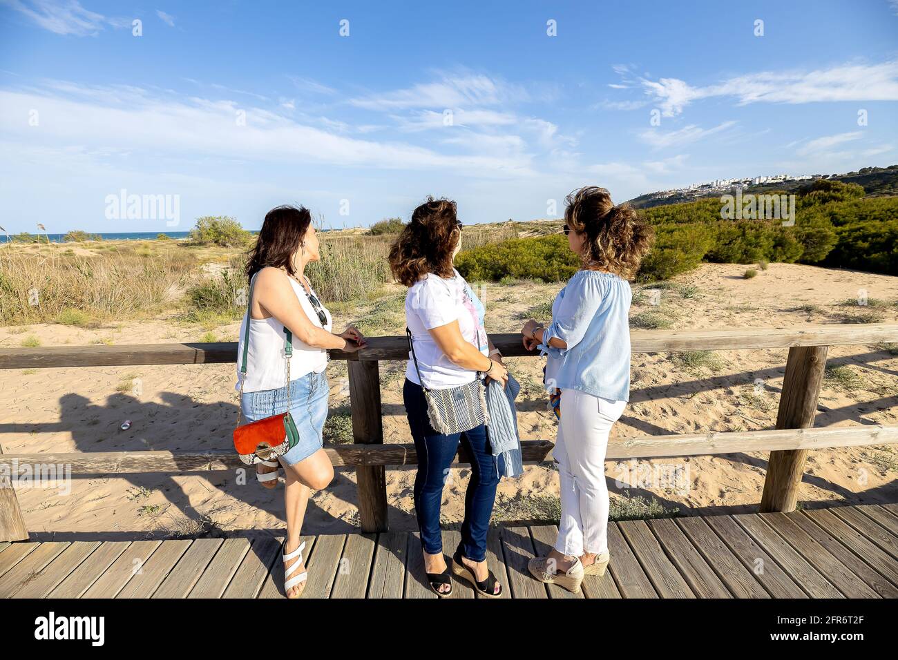 Three women standing hi-res stock photography and images - Alamy