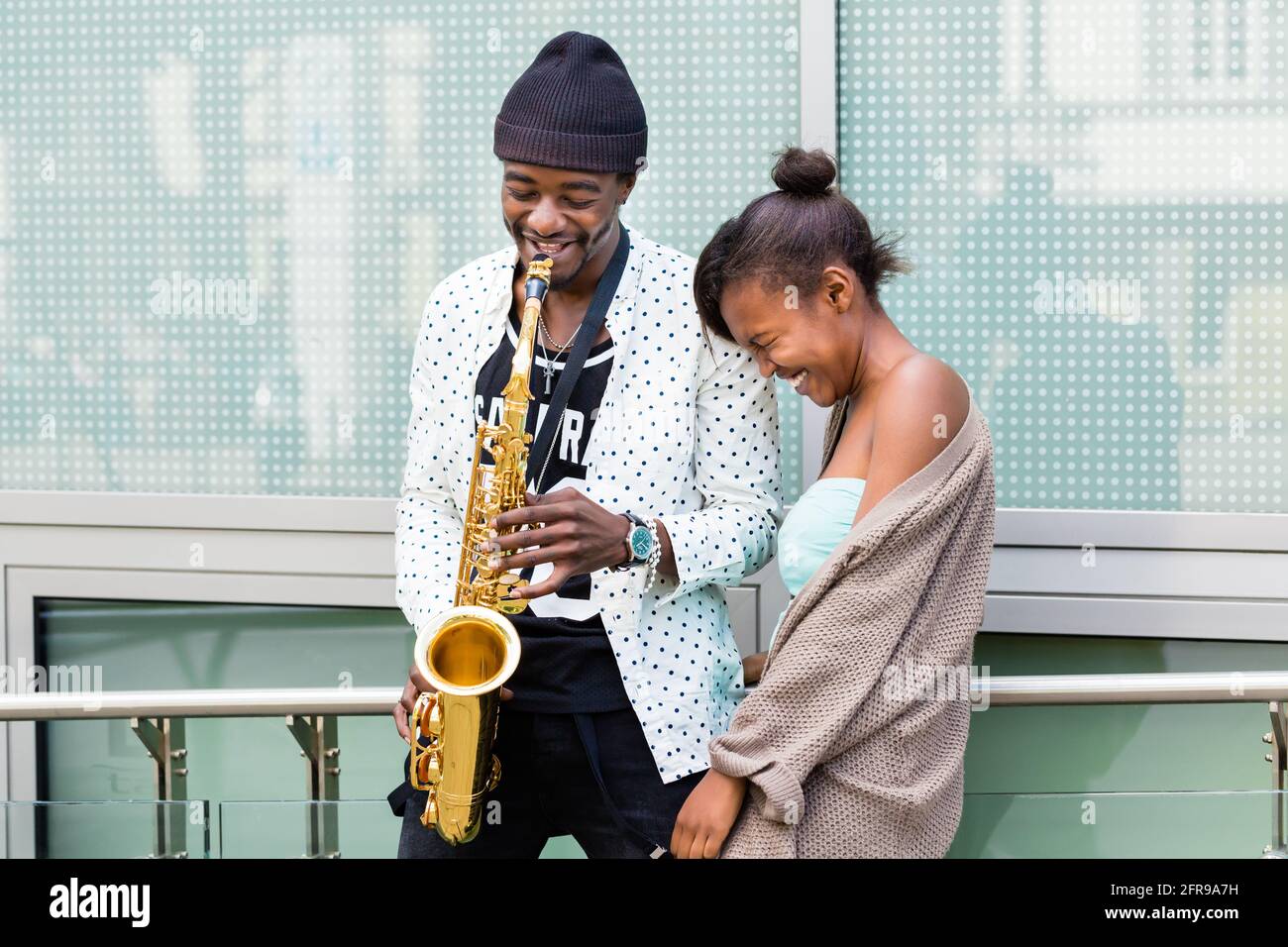 African couple playing Saxophone Stock Photo - Alamy