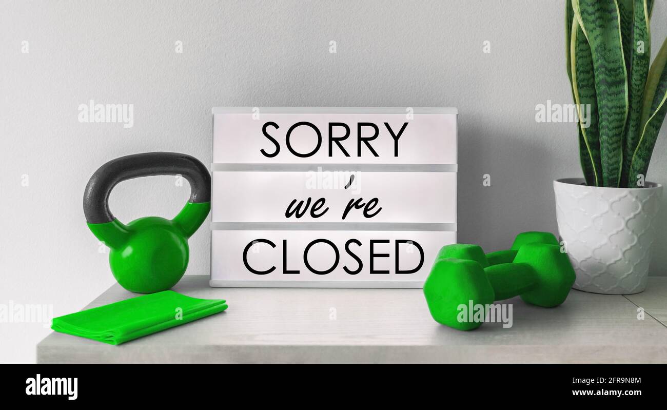 Sorry we are Closed Sign at fitness center gym storefront with training ...