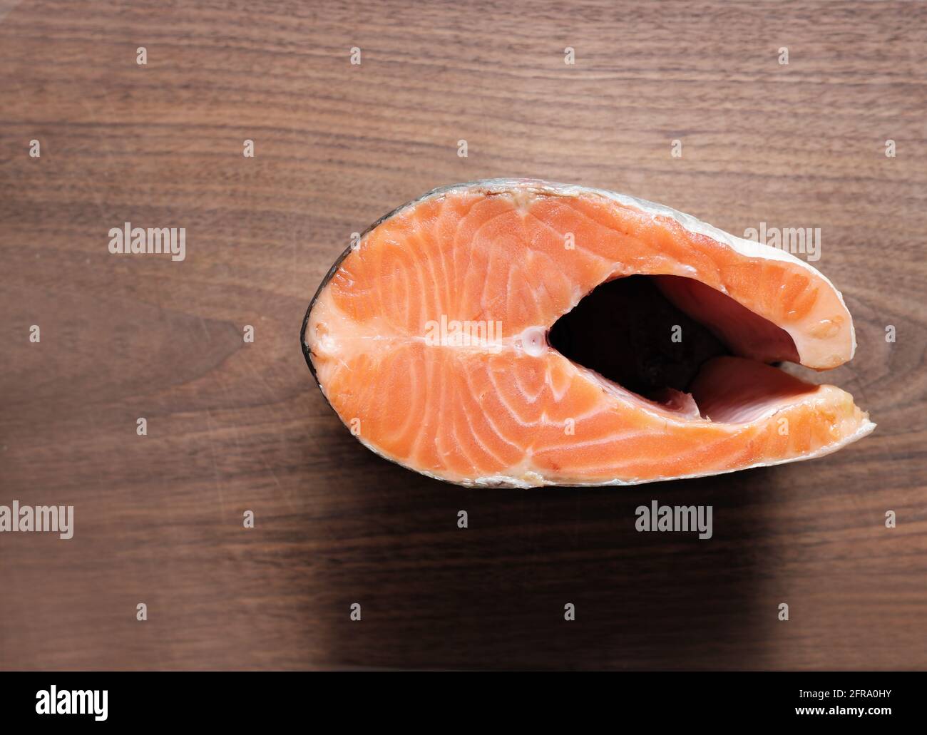 fresh raw salmon steak on wooden kitchen cutting board. fish menu as ...