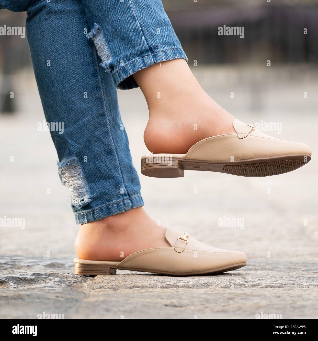 Closeup of a person wearing stylish and beautiful beige colored leather ...
