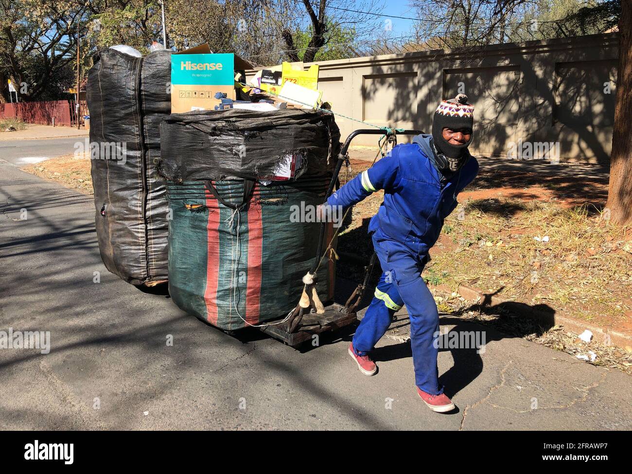 Johannesburg, South Africa. 10th Aug, 2020. A garbage collector walks ...