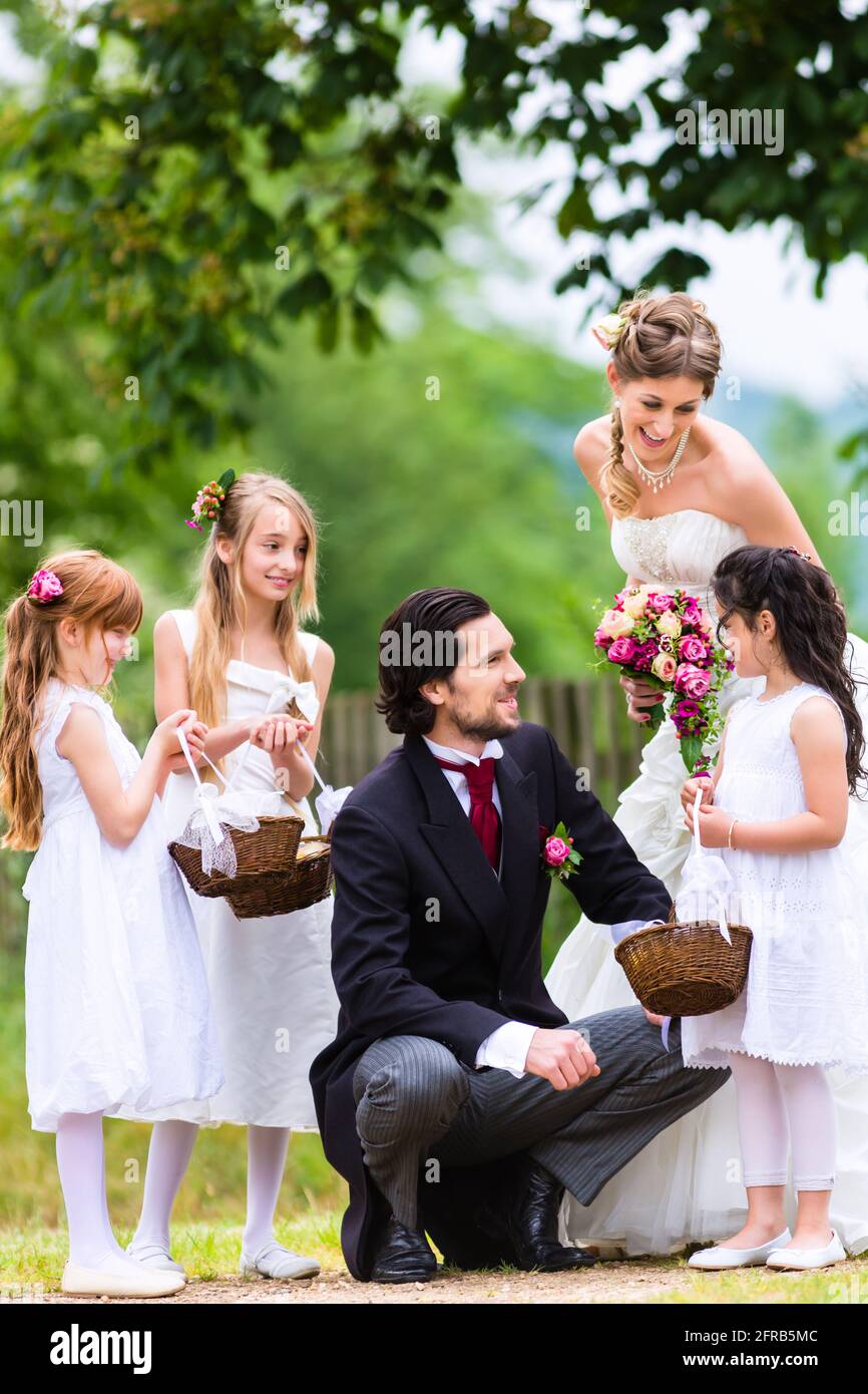 Happy bridal couple at wedding with bridesmaid children Stock Photo - Alamy