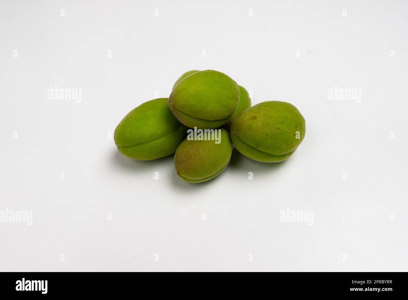 unripe almonds on white background Stock Photo - Alamy