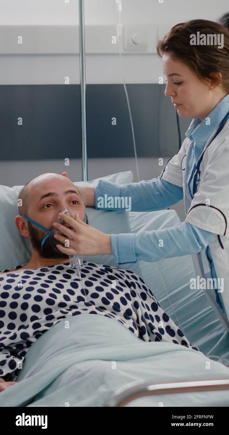 Medical team monitoring heartbeat pulse of sick man during respiratory ...