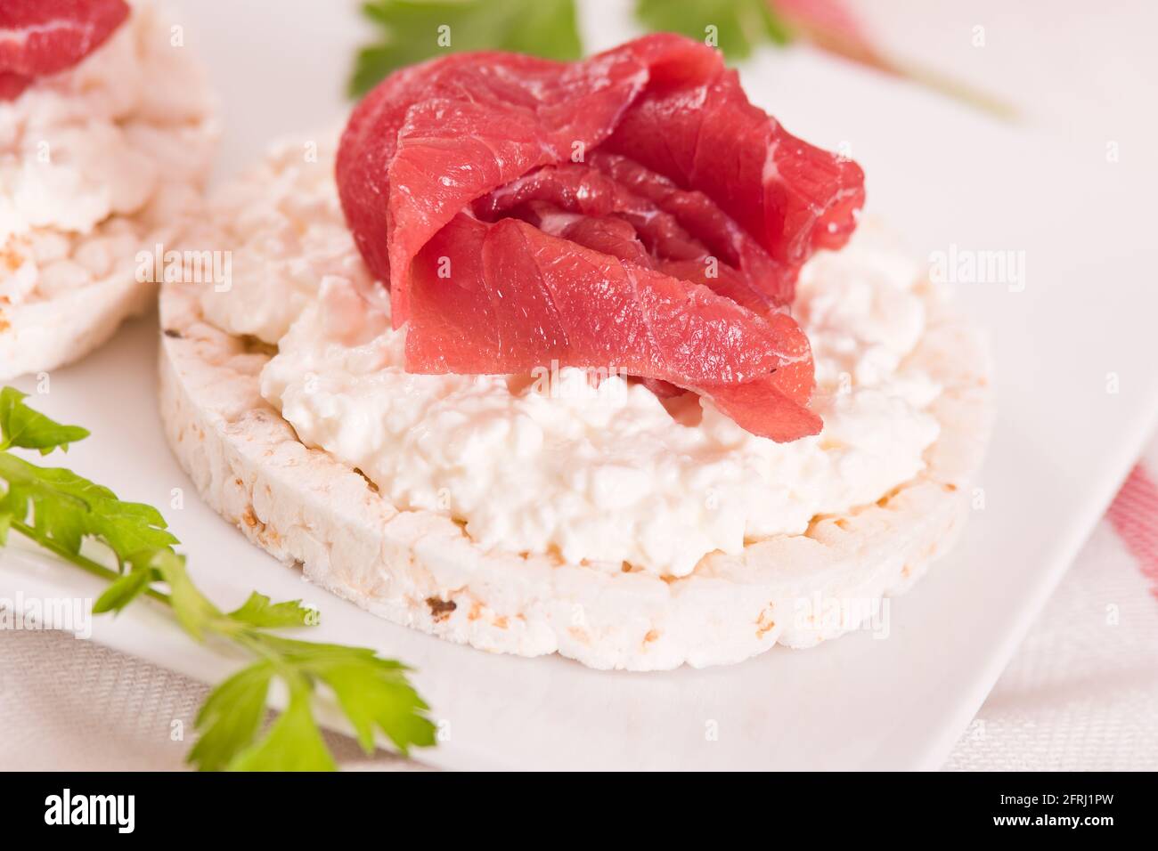 Rice cakes with milk flakes and cold beef Stock Photo - Alamy