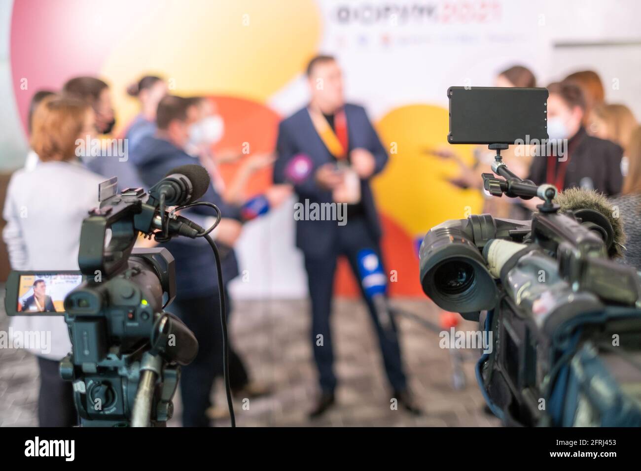 Camera recording video of interview with unrecognizable businessman ...