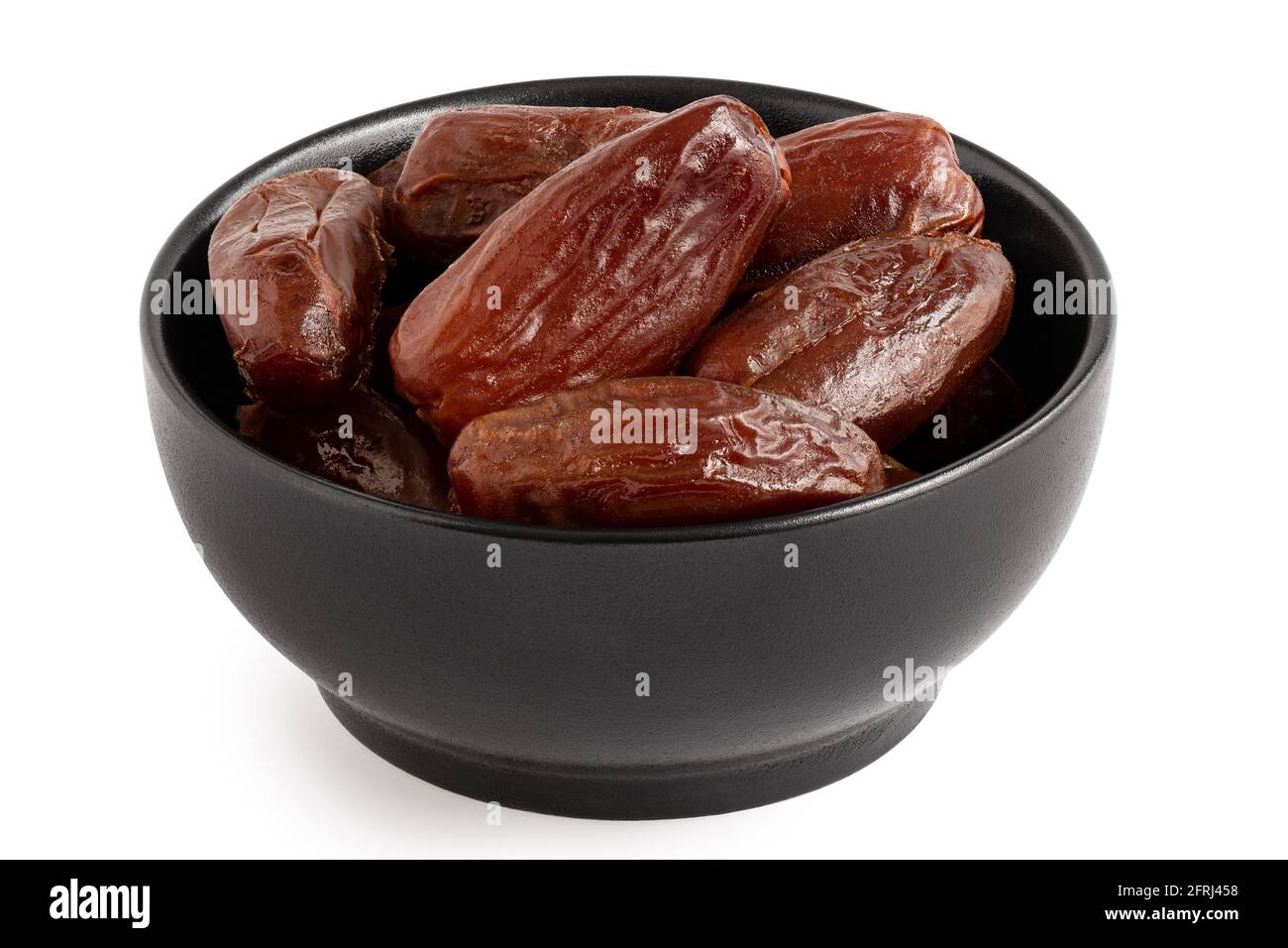 Dry pitted dates in a black bowl isolated on white Stock Photo - Alamy