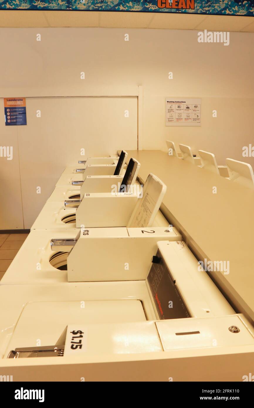 Row of white coin operated washing machines in a laundromat Stock Photo ...