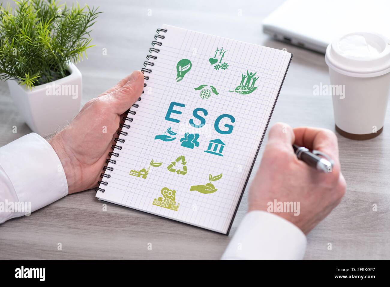 Hand holding a notepad with esg concept Stock Photo - Alamy