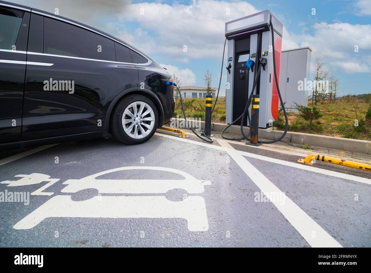 EV car plugged in charger and EV Charger station. Electric car charger ...