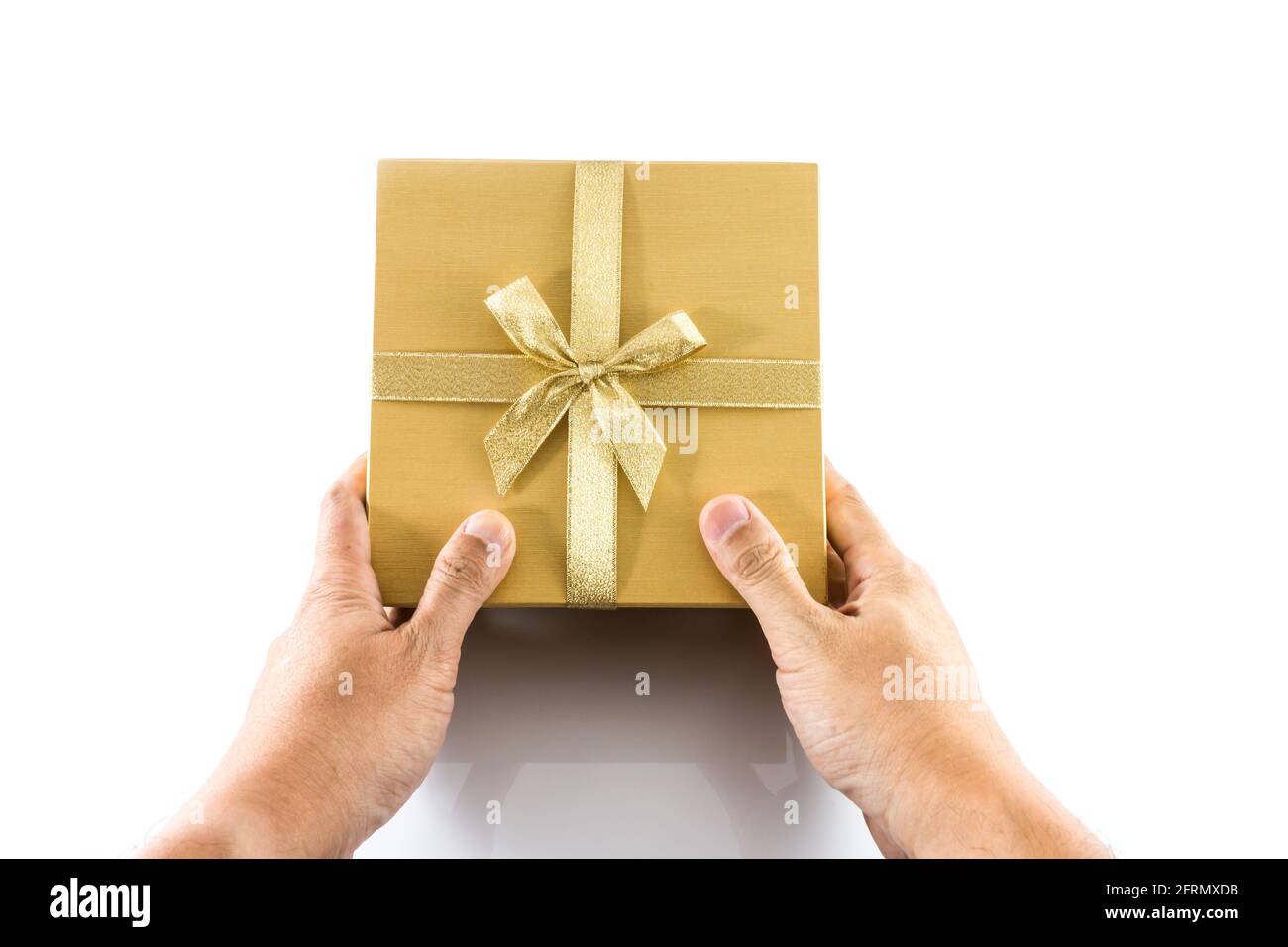 Hand give golden gift box with golden bow isolated on white background ...