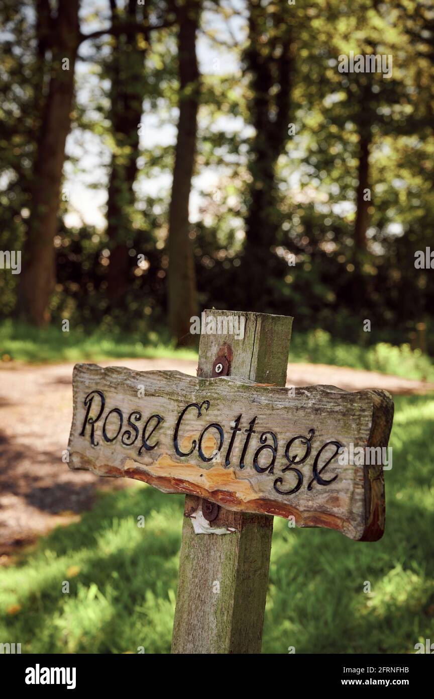 Old wooden sign for Rose Cottage at end of driveway Stock Photo - Alamy