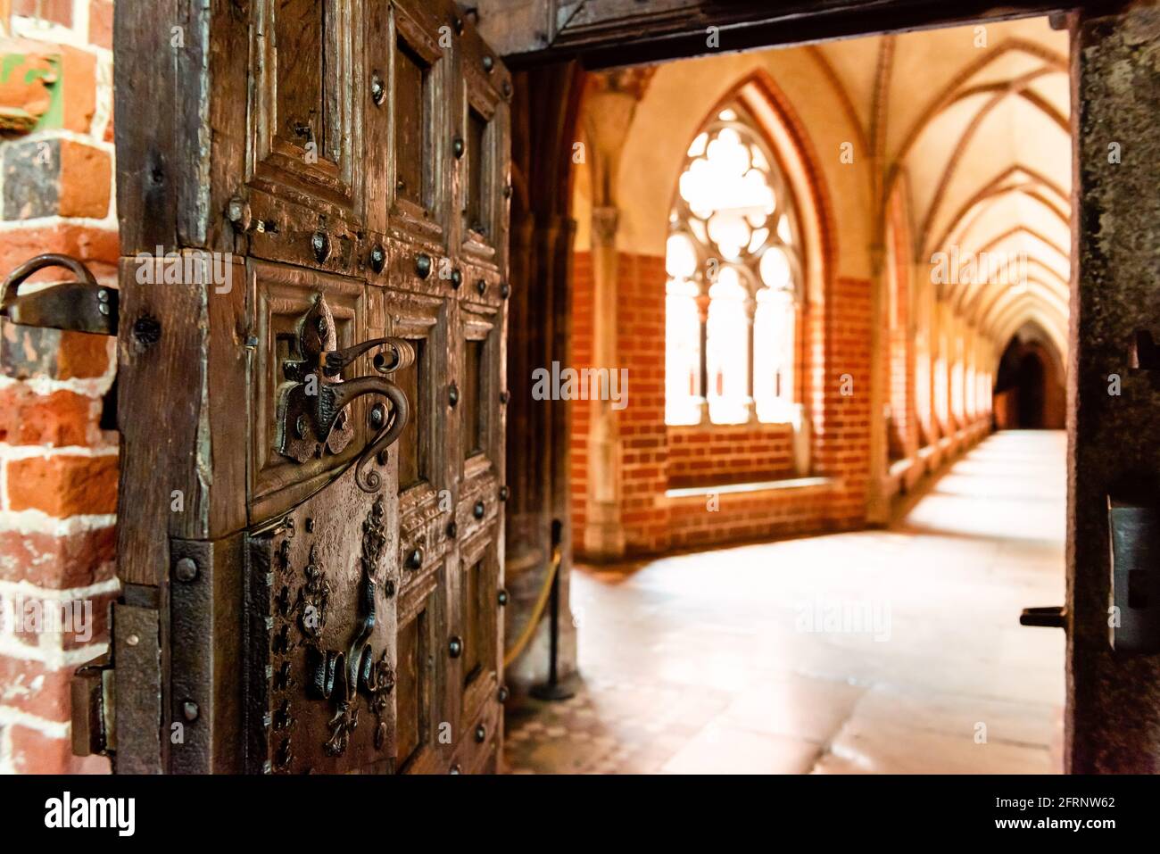 Old open wooden door with carved pattern and metal knob in a medieval ...