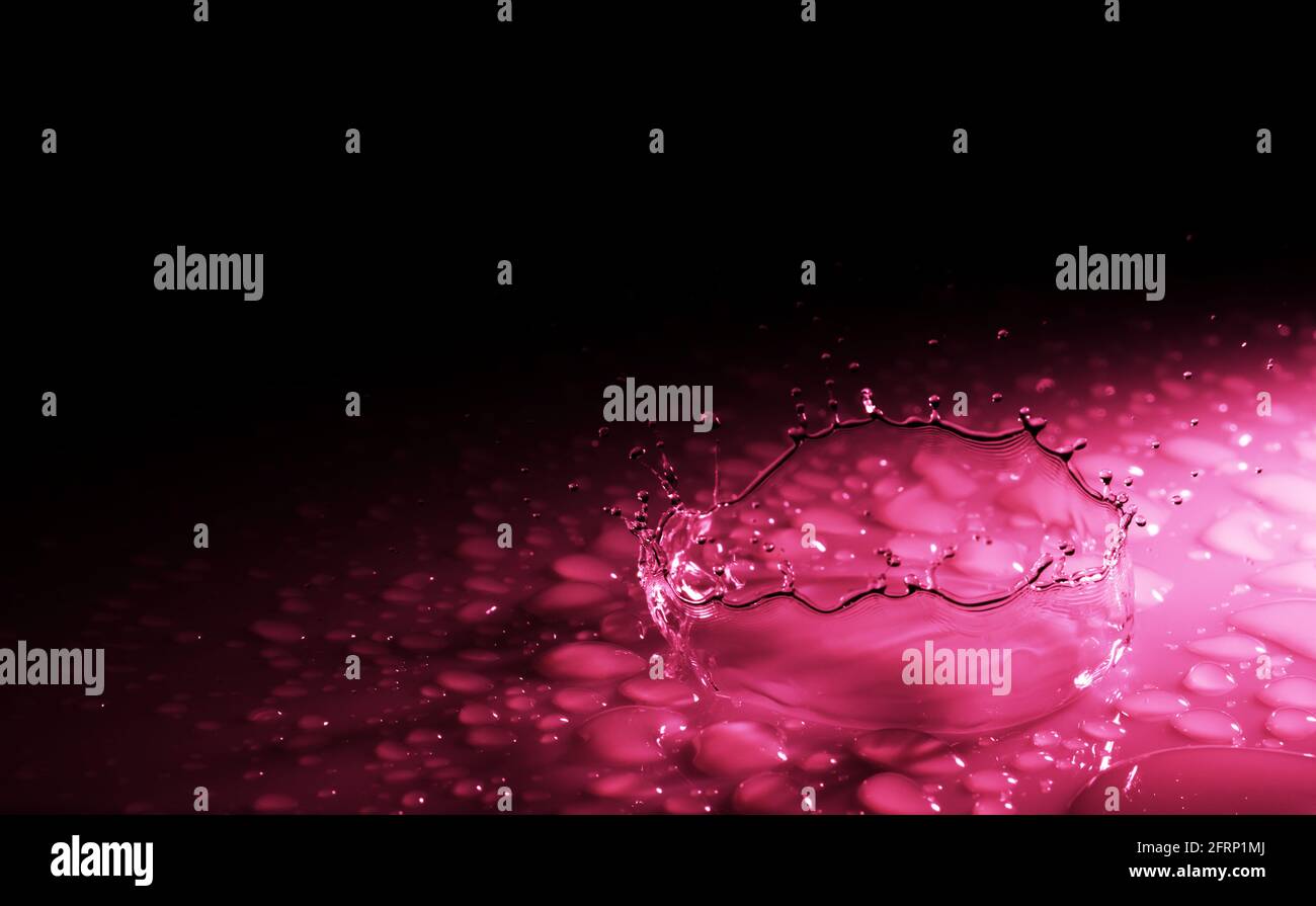 Beautiful splash crown from a drop of water falling on a hard surface ...