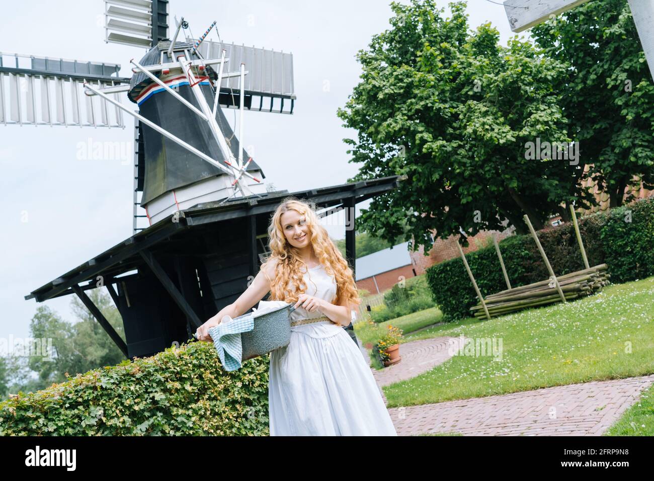 Woman dressed on traditional Dutch dress wooden shoes yellow clogs ...