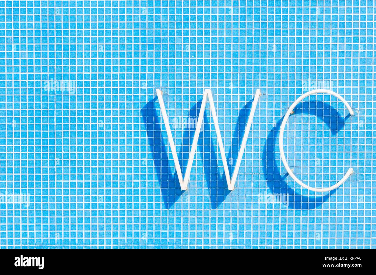 WC sign for toilet on blue wall Stock Photo - Alamy