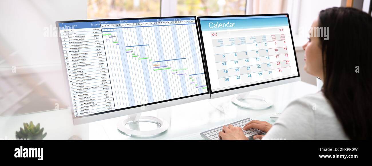 Business Woman Using Calendar On Computer Screens Stock Photo - Alamy