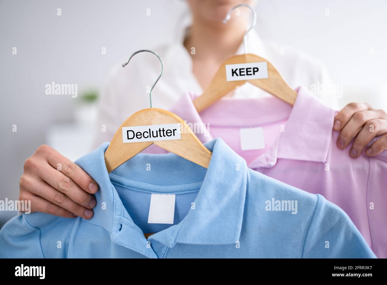 Woman Decluttering Clothes, Sorting And Cleaning Up Stock Photo - Alamy