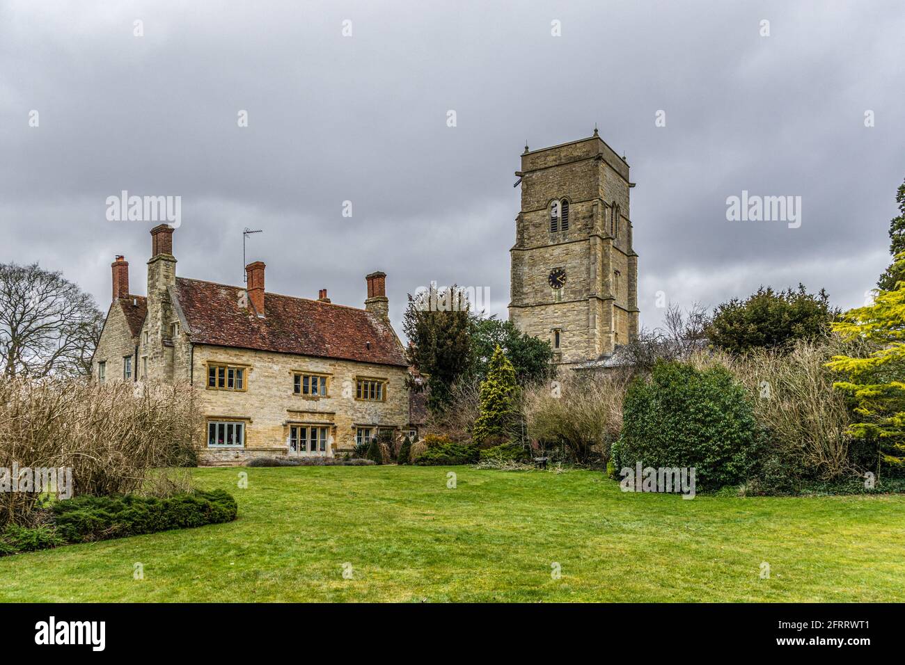 Manor Farm next to the church of St John Evangelist in the village of ...