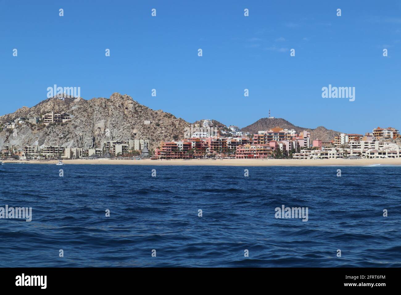 Beautiful shot of oceanside resorts with rocky mountains in the ...
