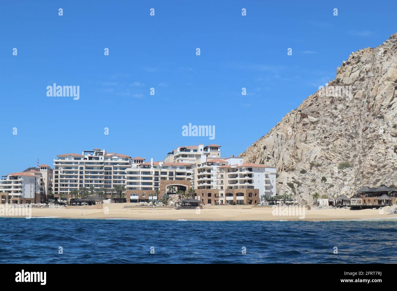 Beautiful shot of oceanside resorts with rocky mountains in the ...