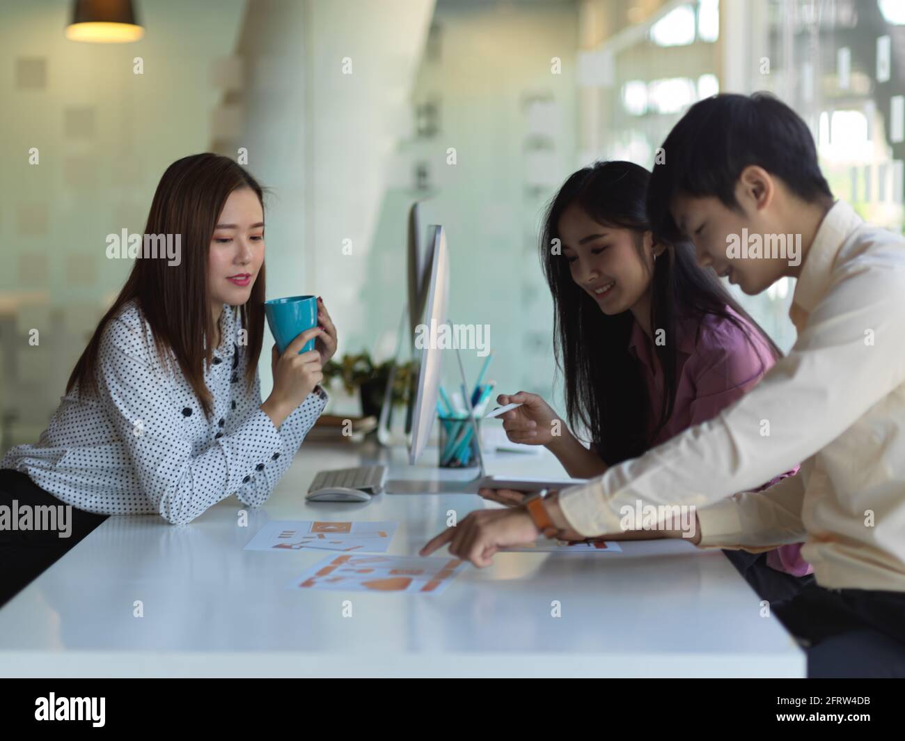 Portraits of UI developer team meeting on their project with tablet and ...