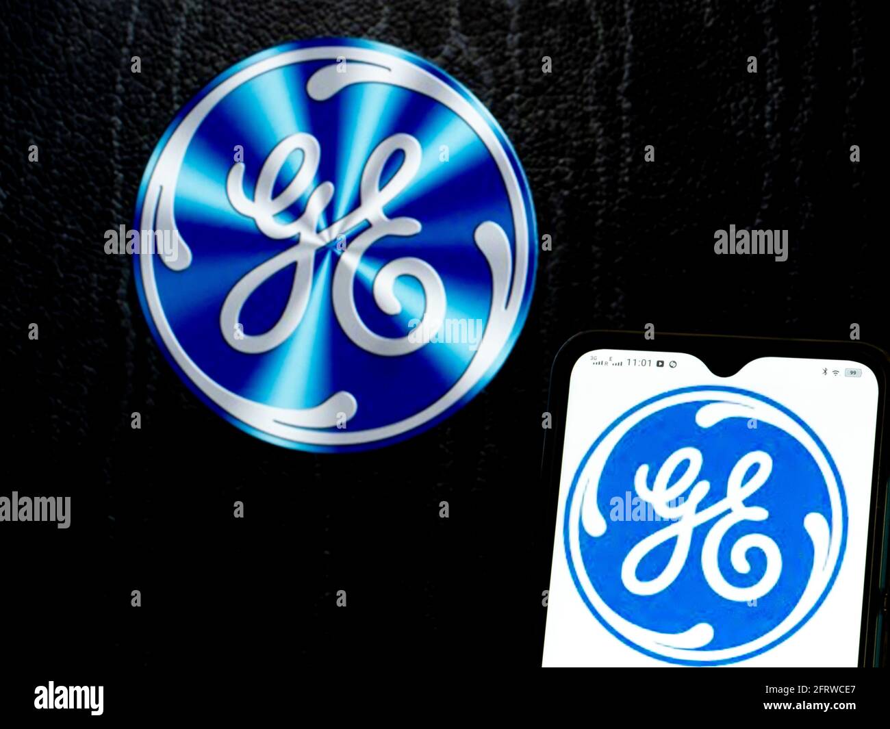 In this photo illustration General Electric Company logo seen displayed ...