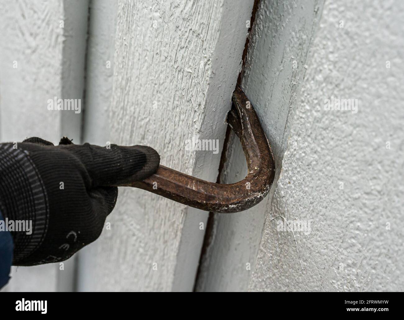 Crowbar held in hands while breaking down the wooden wall Stock Photo ...