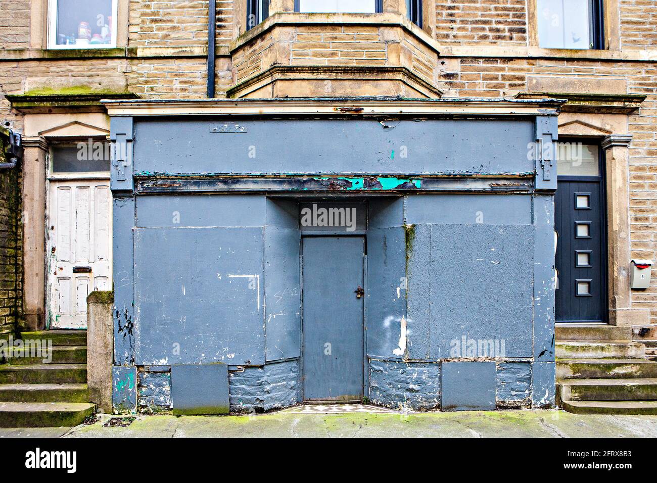 Neglected and boarded up shop front in seaside town Stock Photo - Alamy