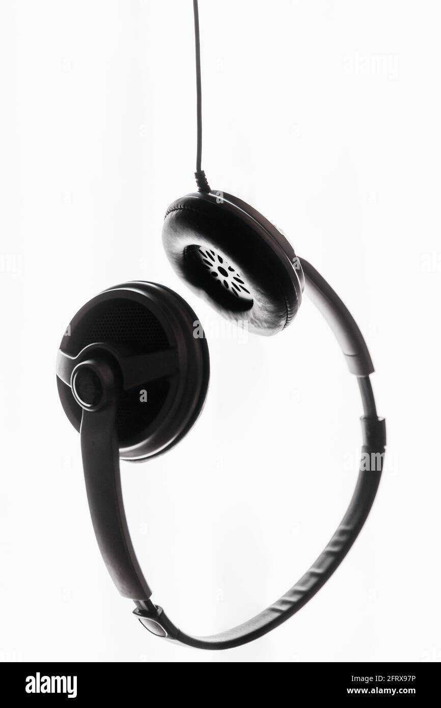 Head phones hangs upside down with white background Stock Photo - Alamy