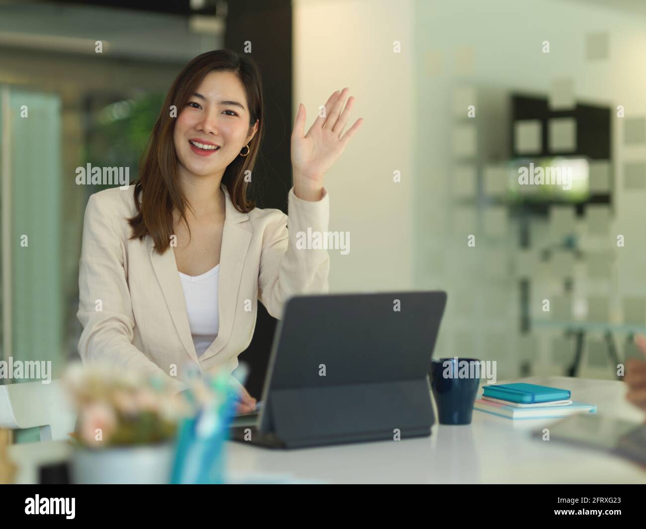 Portrait of female office worker raise hand up waving palm hi greeting ...