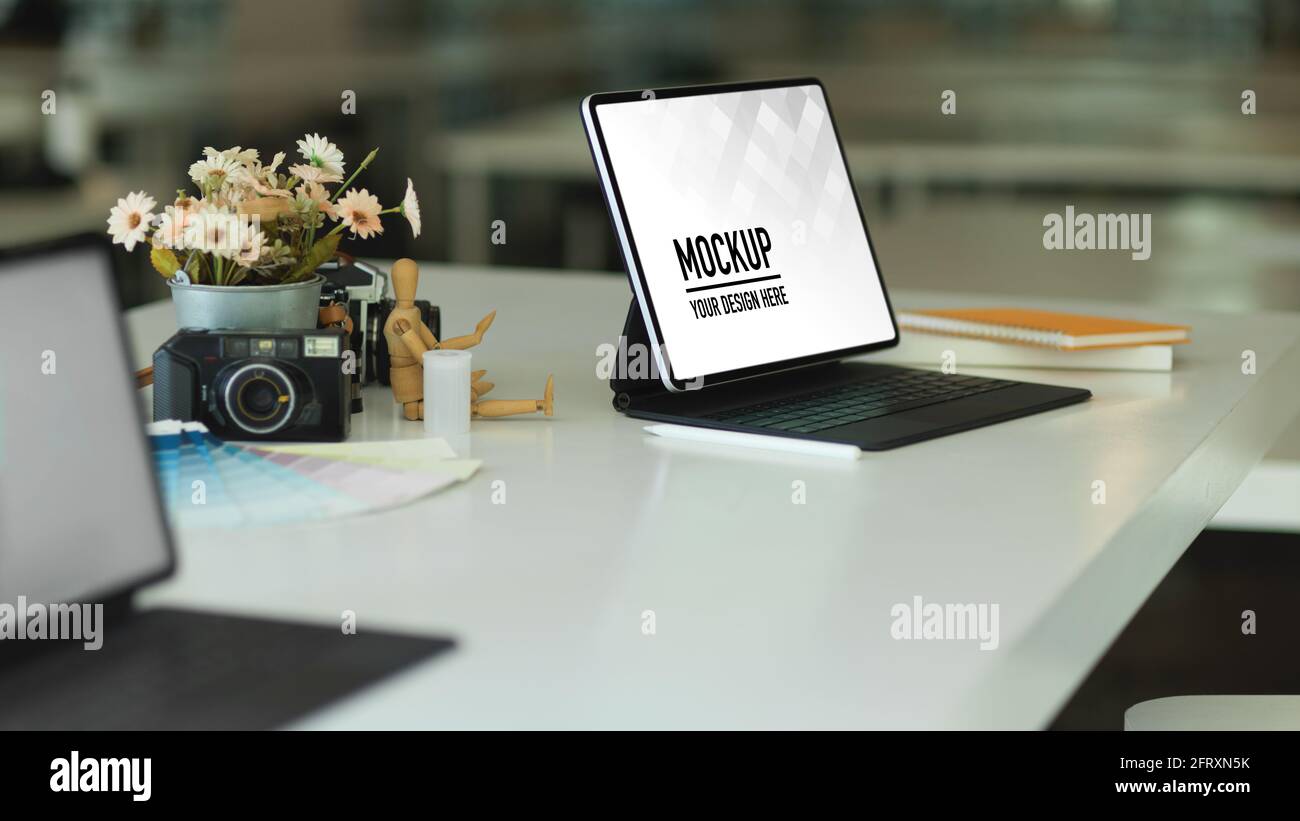 Side view of meeting table with two tablet, stationery and office ...