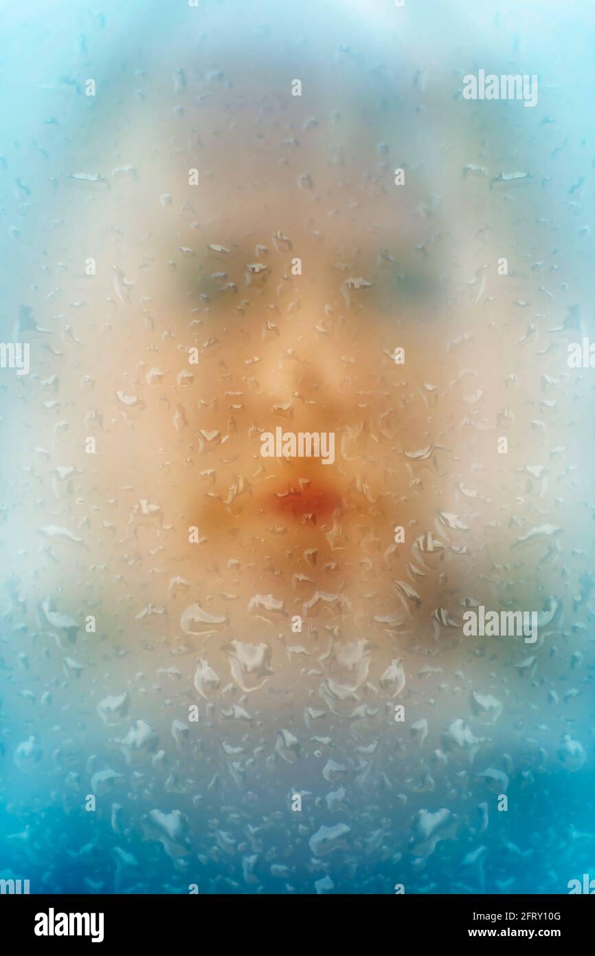 woman face behind a glass with drops of water Stock Photo - Alamy