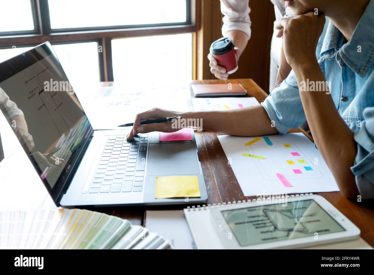 Group of young designer working in the office to design a new product ...