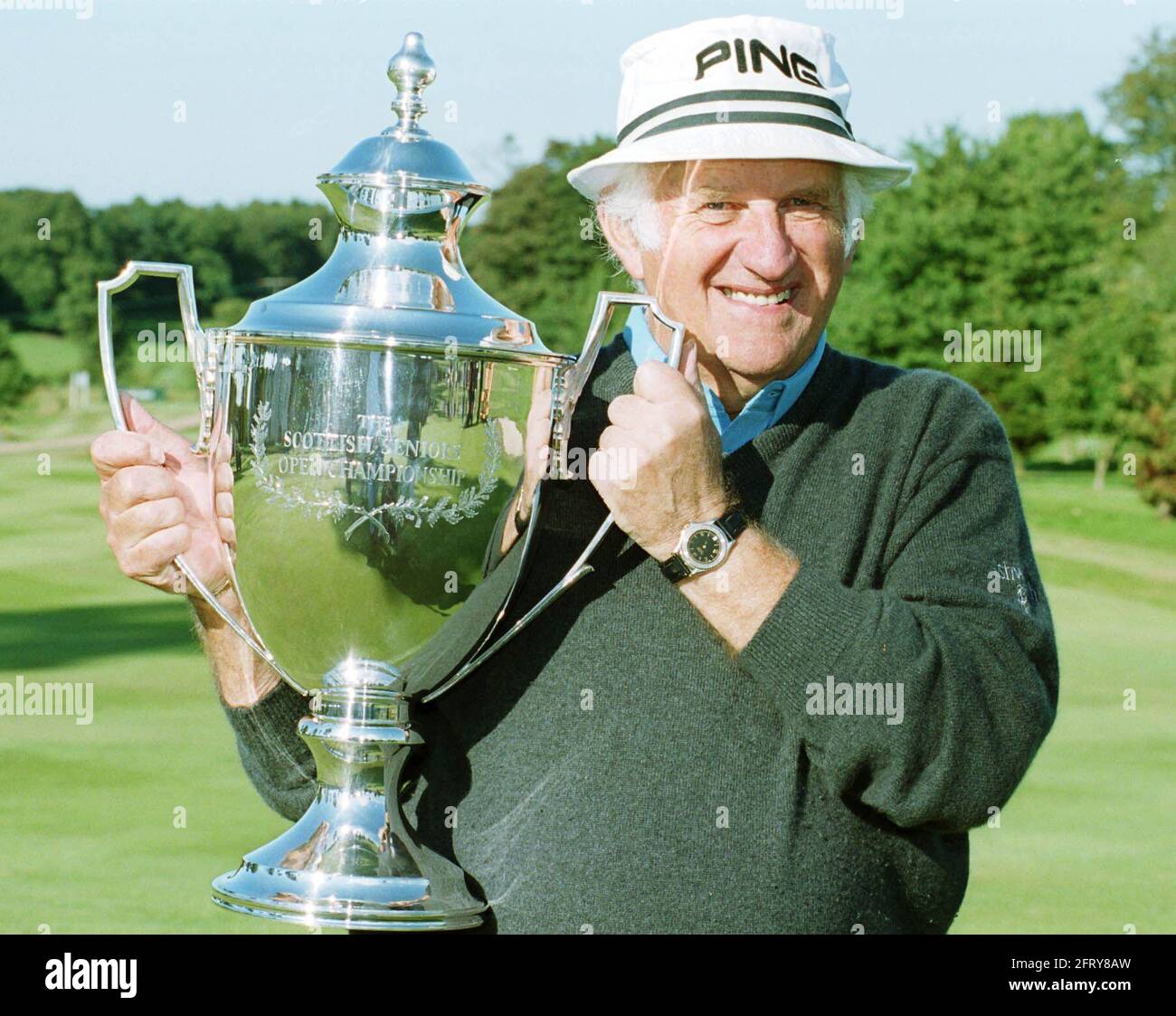 winner Neil Coles holds aloft the Scottish Seniors trophy at Dalmahoy ...