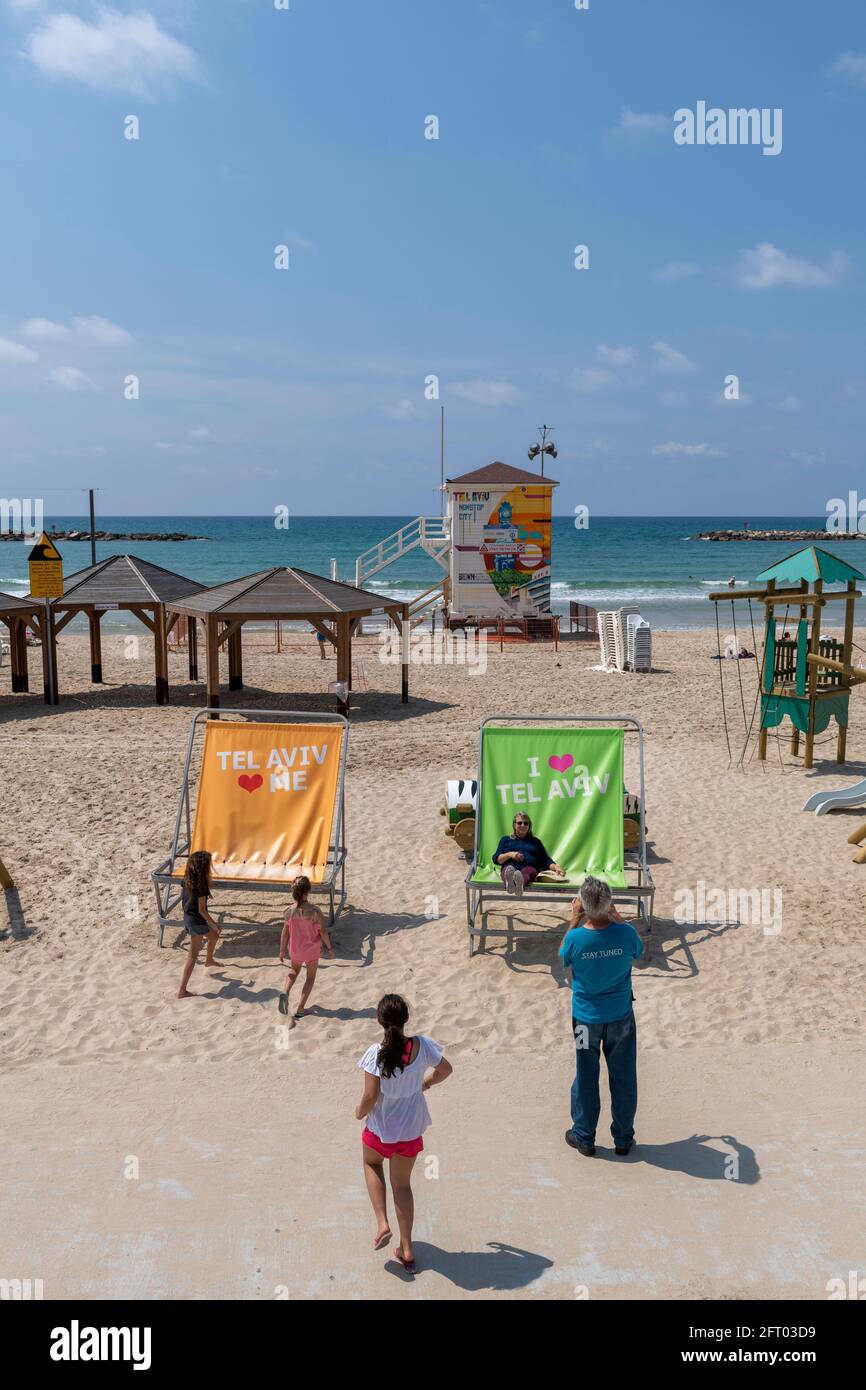Tourists enjoy while taking photos on the beaches of Tel Aviv. Israel ...