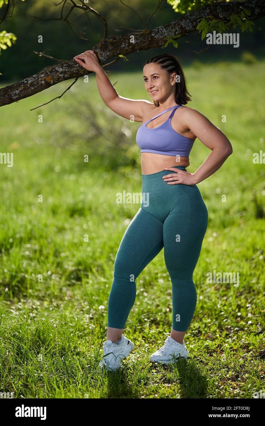 Plus size young beautiful runner woman posing in the forest Stock Photo ...