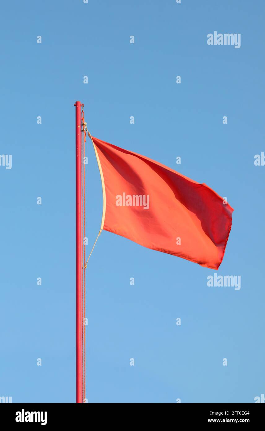 big red flag to signal the danger above the lookout tower Stock Photo ...