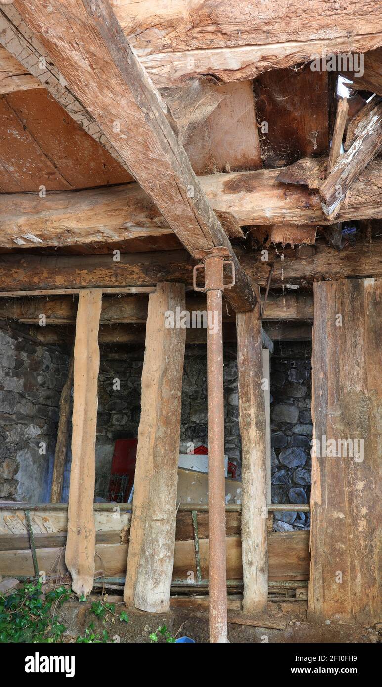 wooden planks in an entrance to a crumbling mine building with supports ...