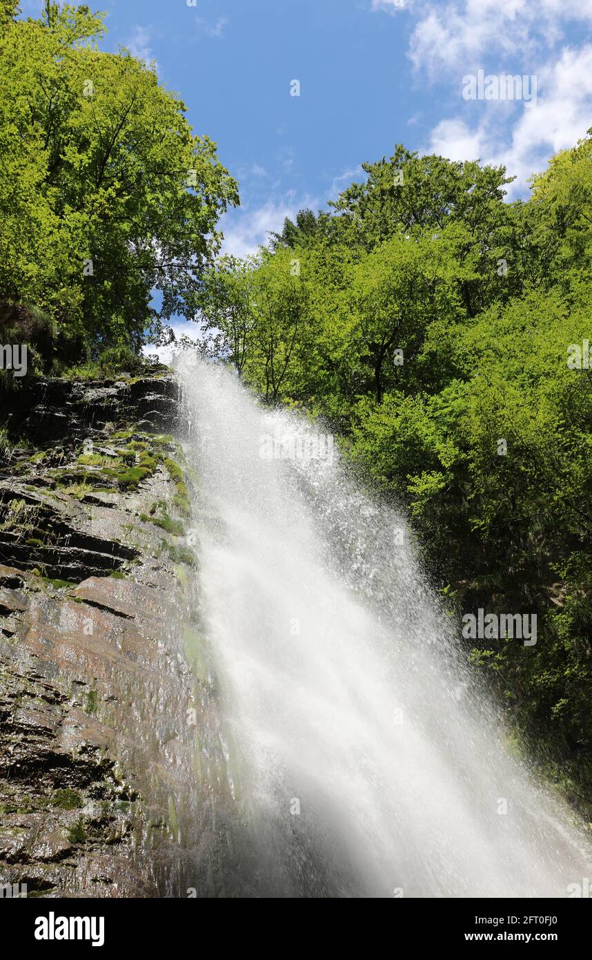 spring of fresh and bubbling water that flows from between the rock in ...